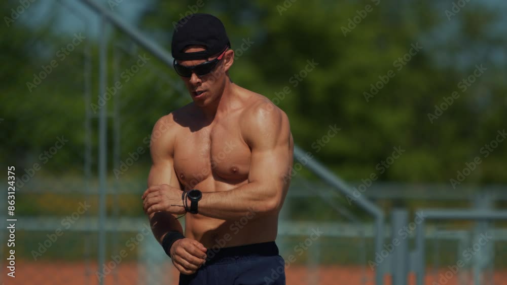 Young muscular man took break between strength exercises and is ...