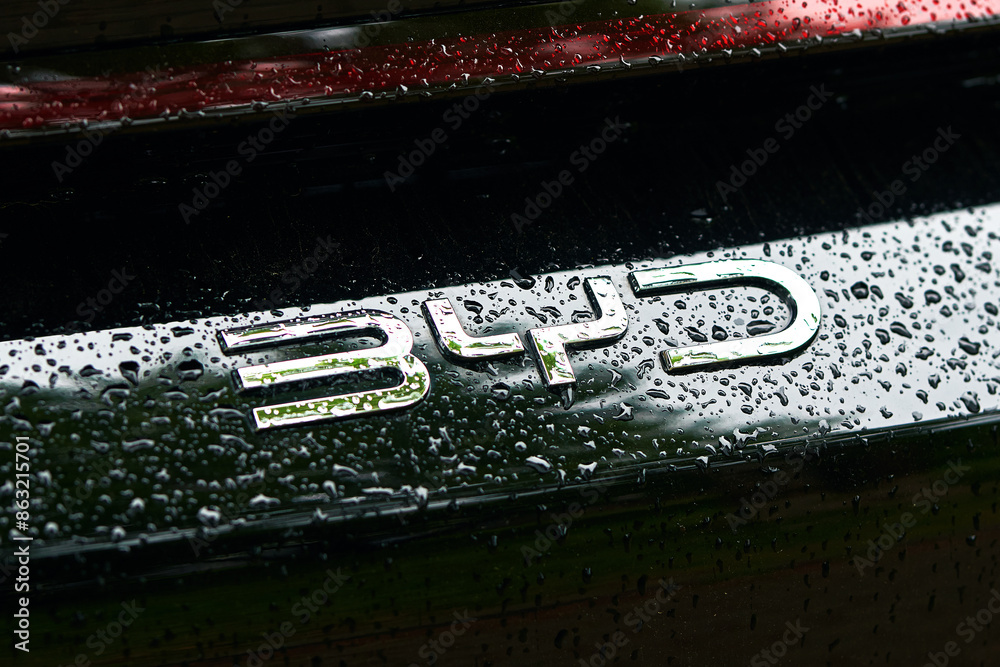 Minsk, Belarus. Jun 10, 2024. BYD car emblem covered in rain closeup ...