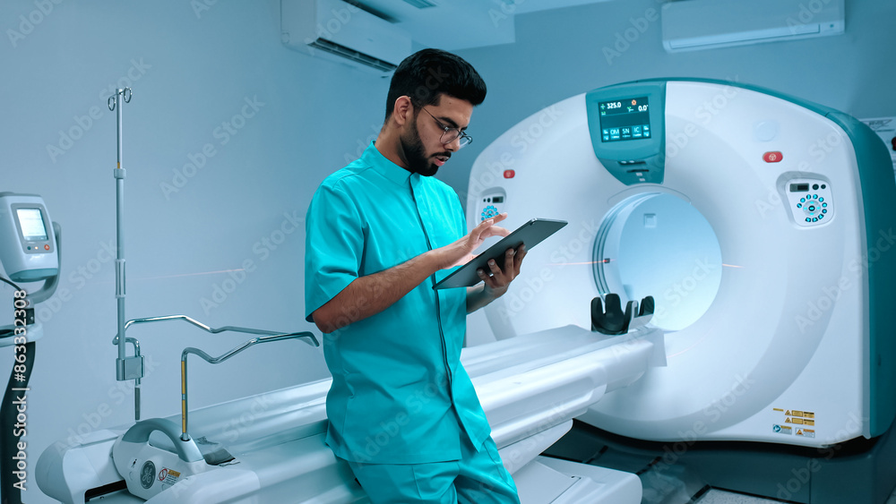 Indian tomographer making notes with pen. Serious doctor at background ...