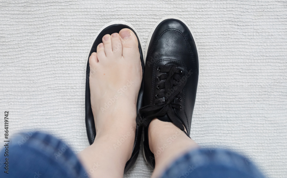 Foot deforming shoes. Incorrect anatomical shoes with flat soles. Small ...