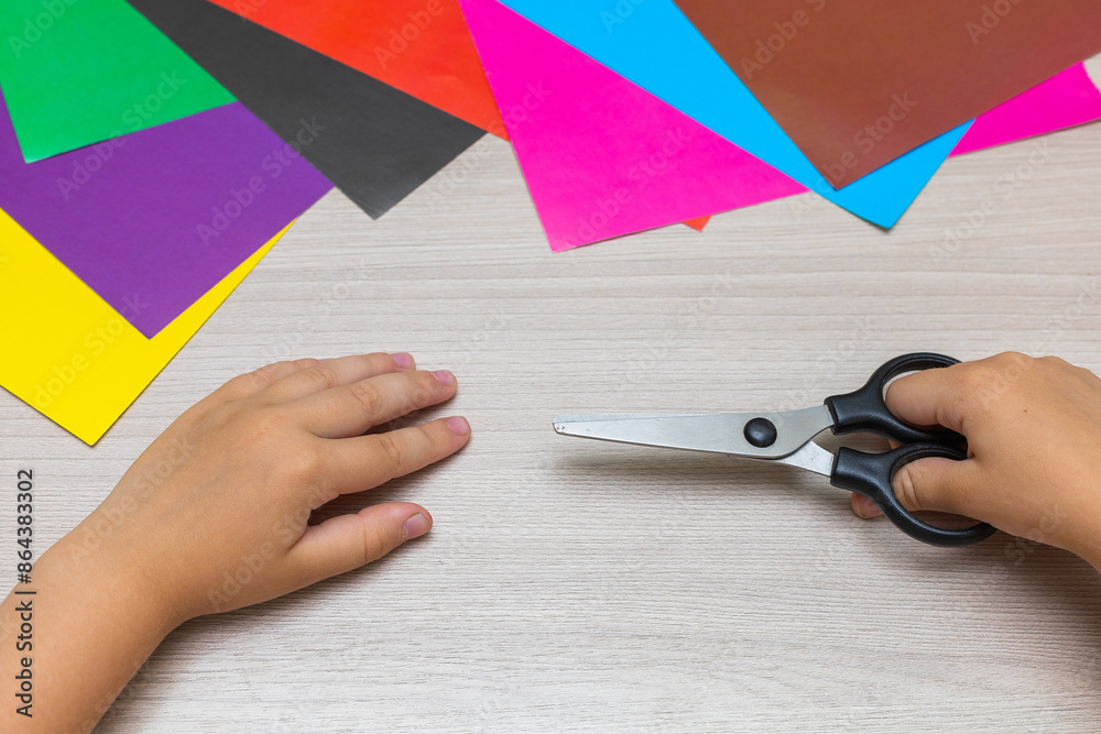 Kid hands cutting colored paper with scissors. Education, learning ...