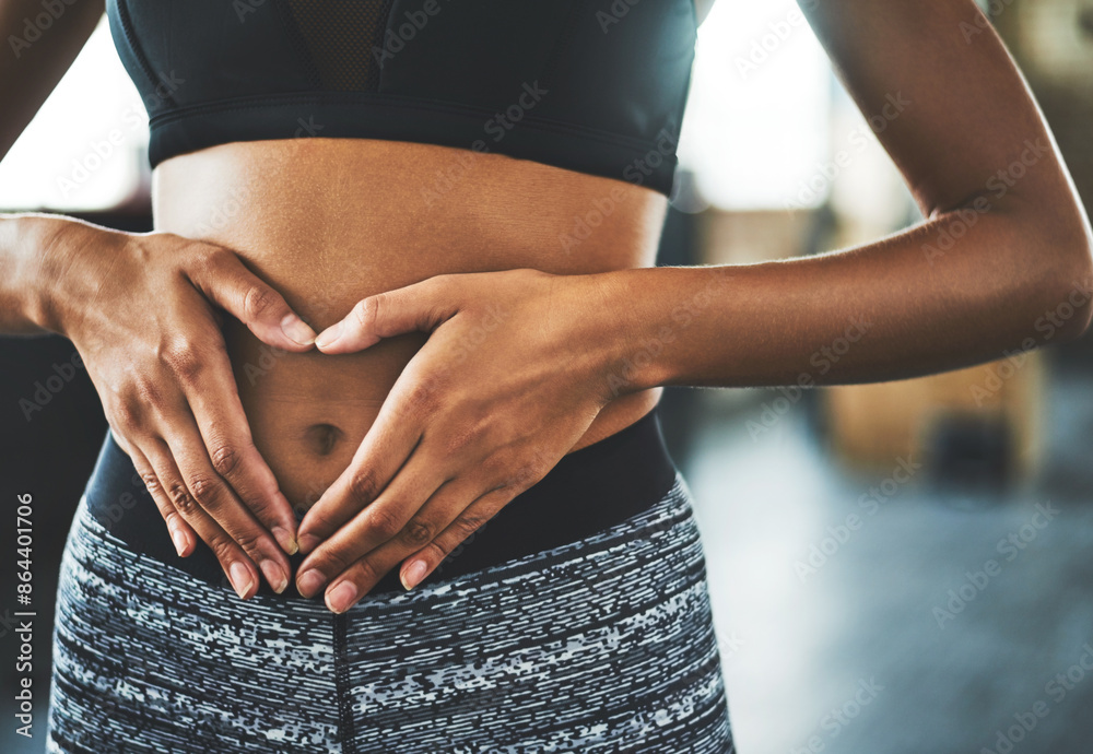 Health, digestion and hands on stomach for woman in gym, nutrition and ...