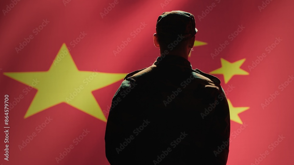Member of chinese army doing saluting hand gesture towards China flag ...