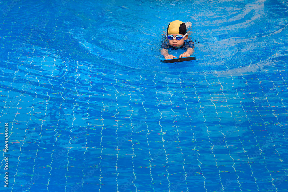 Seriously face child warm up with swimming kickboard before practicing ...