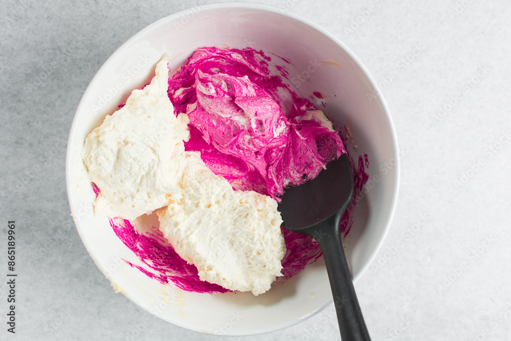 Overhead view of buttercream being colored pink, top view of american ...
