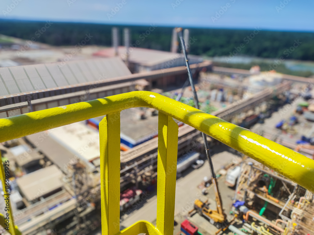 Selectively focus on the yellow handrail which is used as a safety and ...