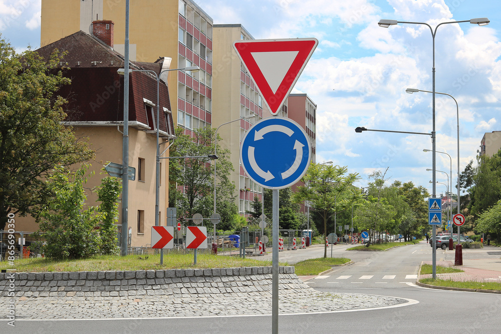 Road signs in front of the roundabout - give way and direction of ...
