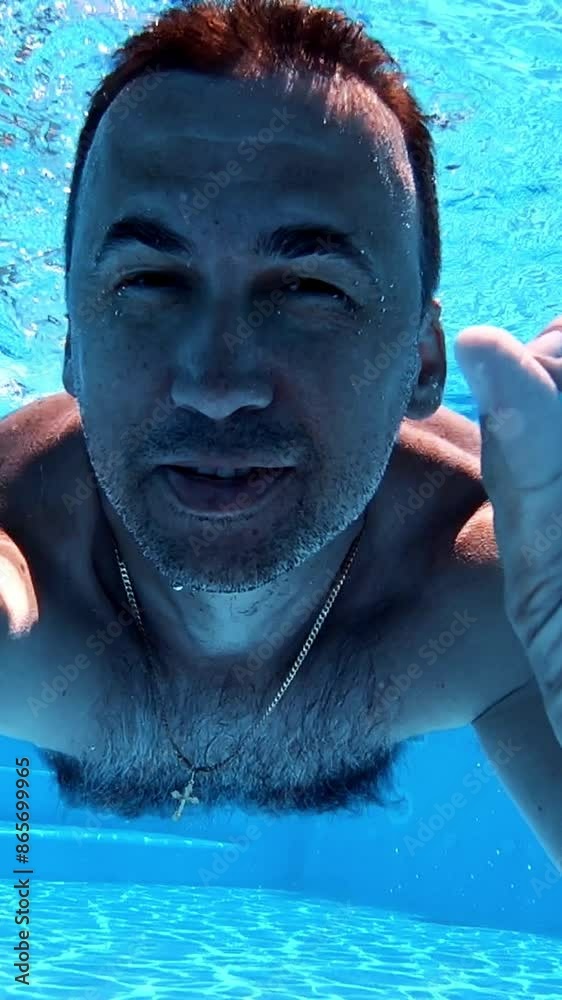 Man swimming underwater. Healthy man diving in the swimming pool and ...