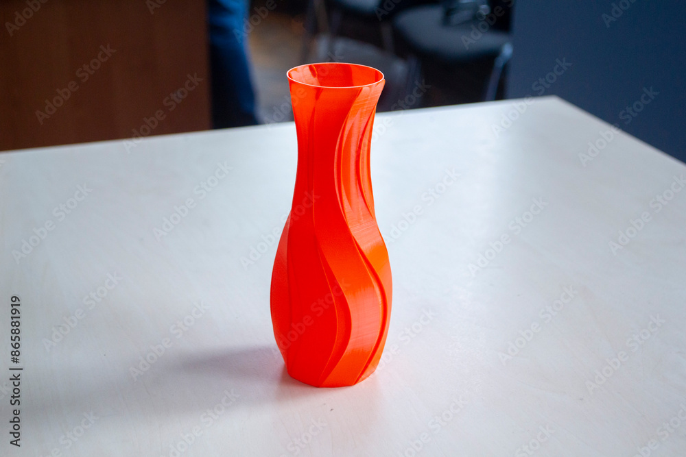 Object in the form of a vase of red color printed on a 3D printer ...