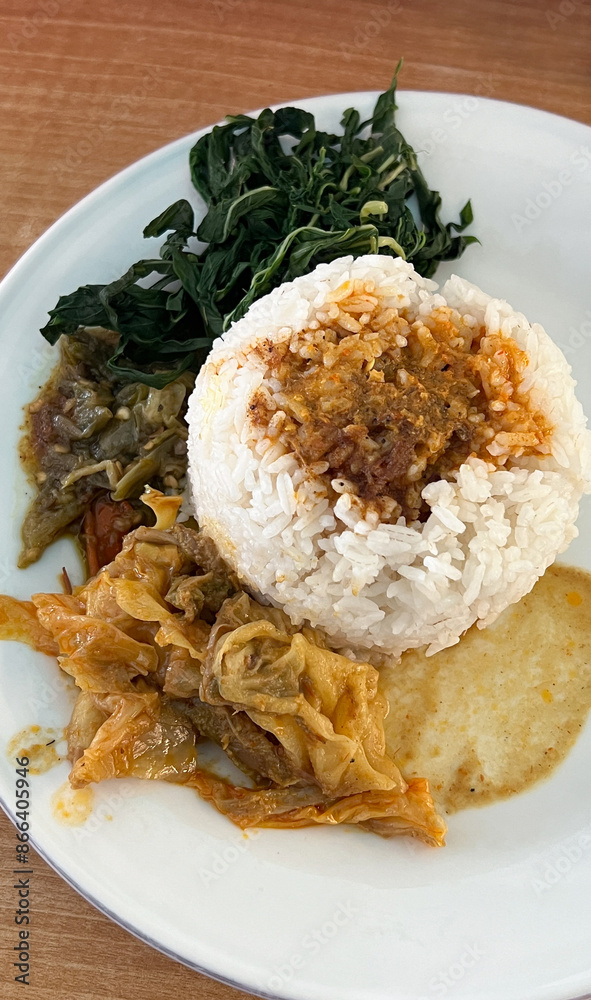 Indonesian cuisine Nasi Padang, rice with beef Rendang, salty anchovy ...