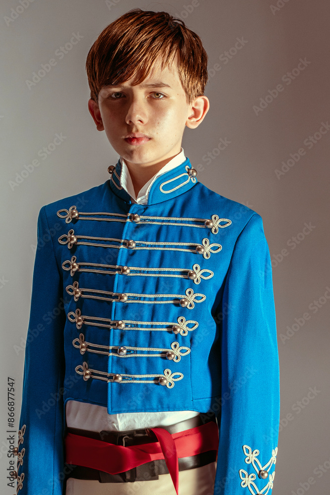 Young teenage male standing with a stoic expression, wearing a vintage ...