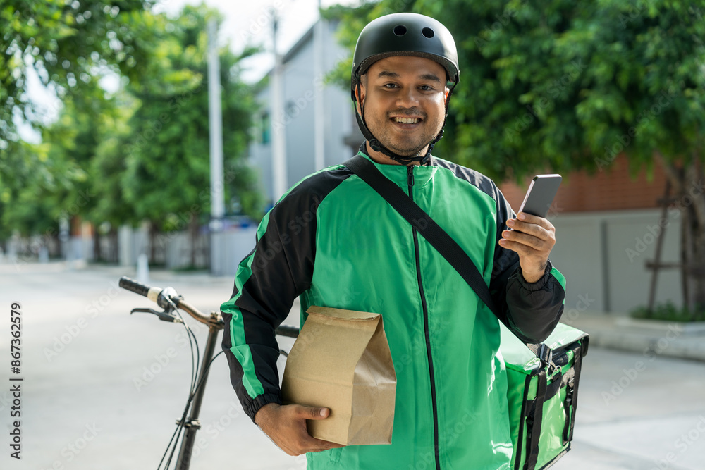 Portrait Rider food delivery man wearing green uniform and helmet ...
