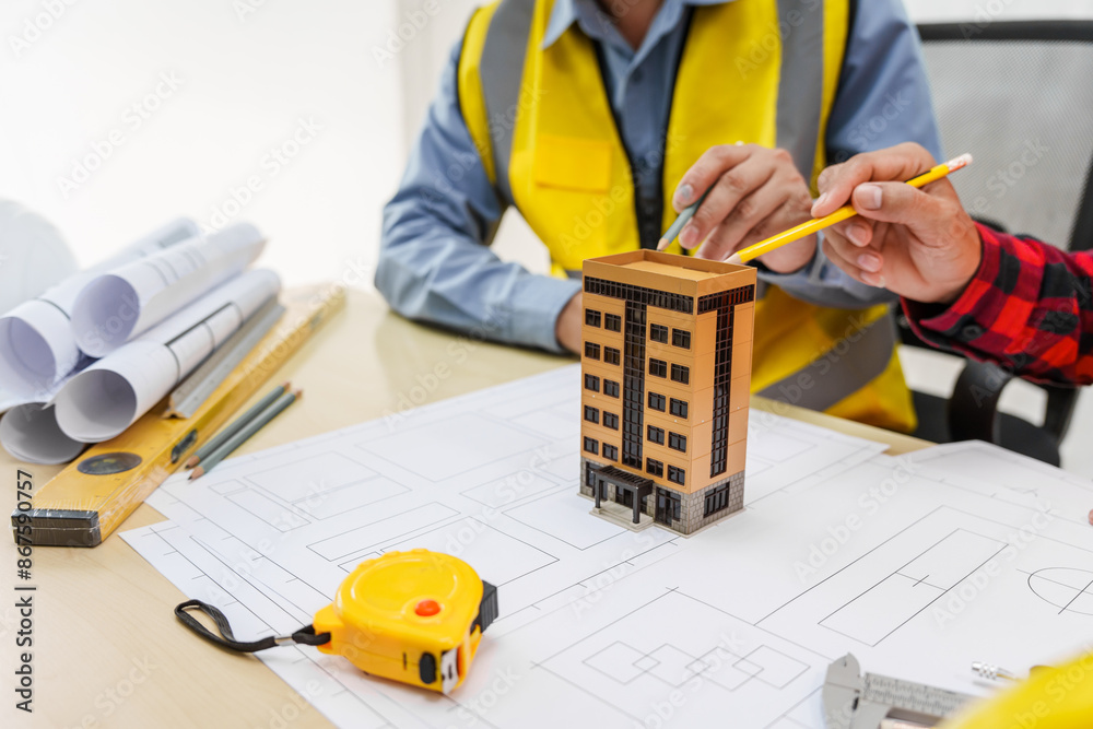Two men, including a male Asian construction contractor engineer ...