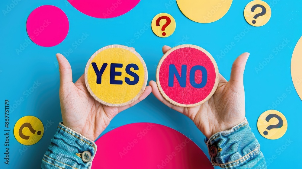 Hand holding wooden discs with "YES" and "NO", question marks in the ...