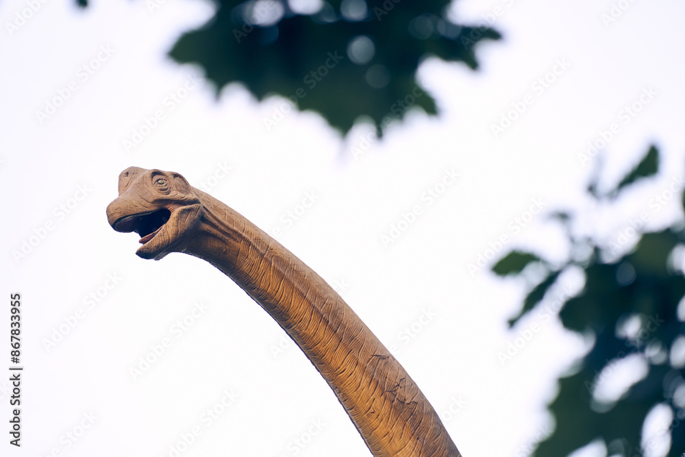 The head of a brachiosaurus is against the sky. The sauropod dinosaur ...