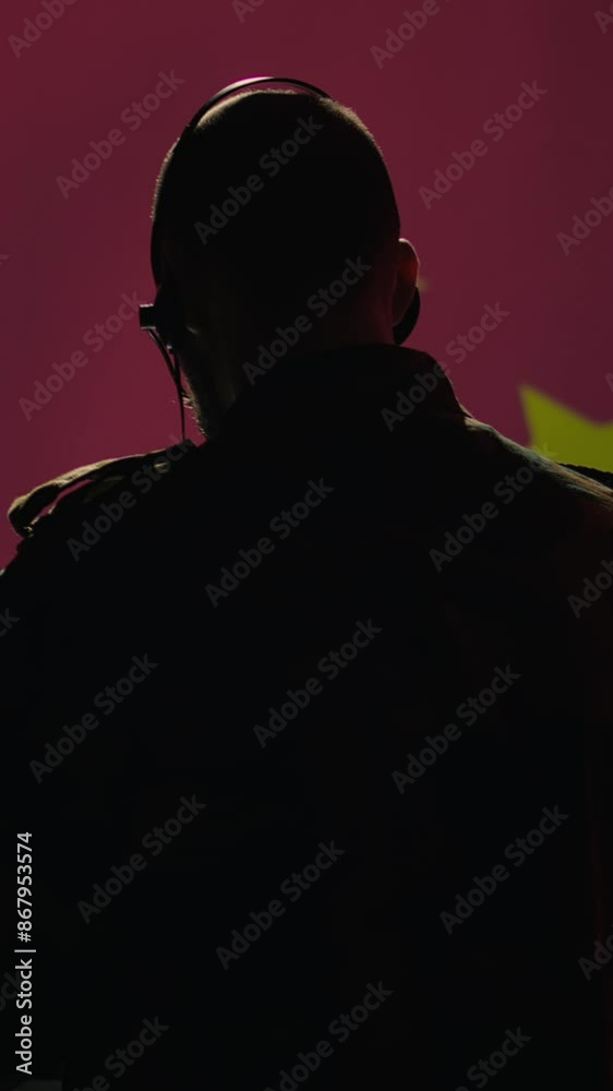 Vertical video Chinese army military dispatcher looking at surveillance transmission on laptop ...