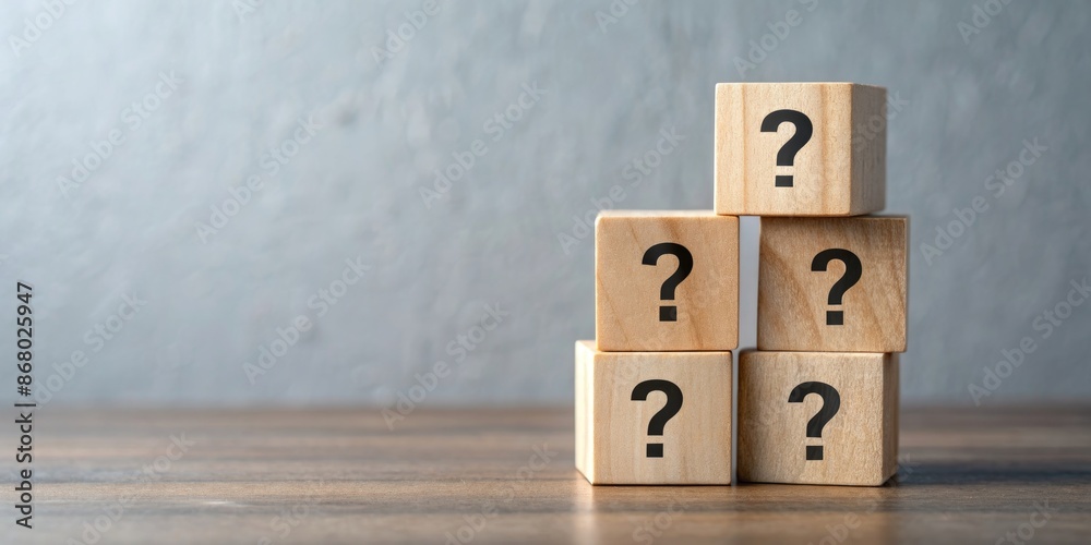 Wood blocks with question marks on grey background with copy space ...
