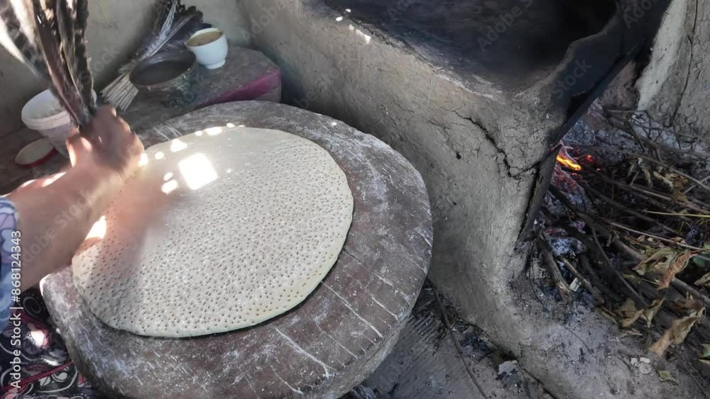 preparing bread in a traditional Dagestan village bakery. Bread is a ...