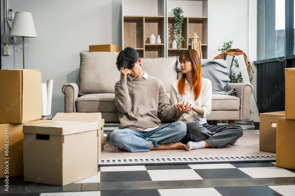 A stressed young couple faces financial challenges, struggling with ...