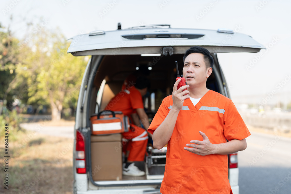 Asian male EMS paramedics or emergency medical technicians in orange ...