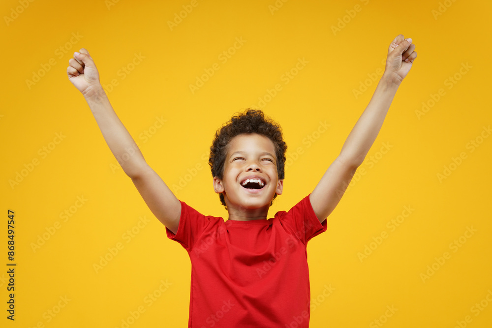 Portrait of euphoric happy kid boy having fun holding his hands up with ...