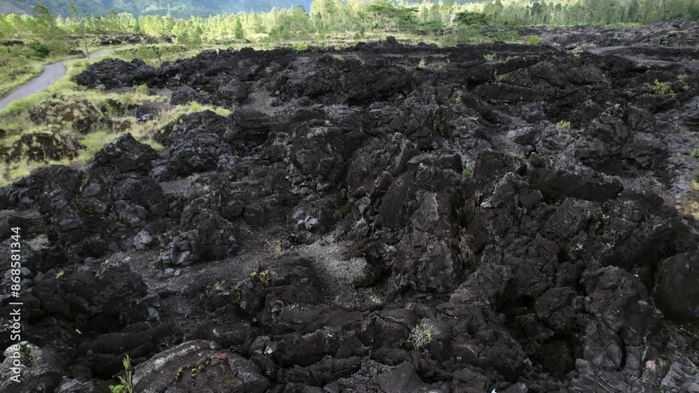 Black blocks and clumps of hardened lava, camera flies over edge of ...