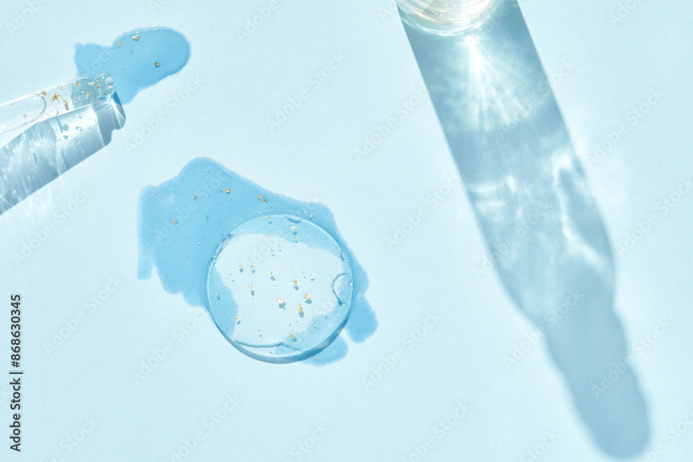 Serum gel texture swatch. Transparent drop with golden sparkles. Blue ...