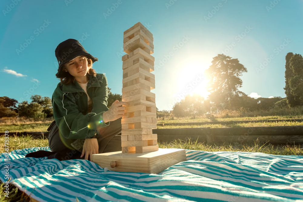Tower game. Happy family with kid playing board games outdoors in the ...