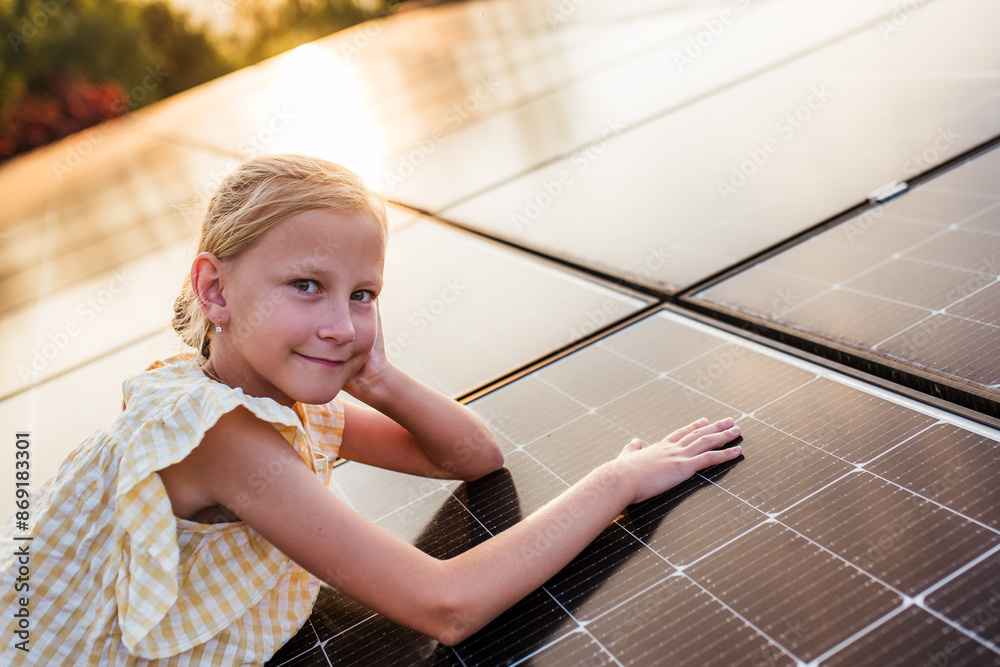 Girl lying on roof with solar panels during sunset, smiling. Rooftop ...