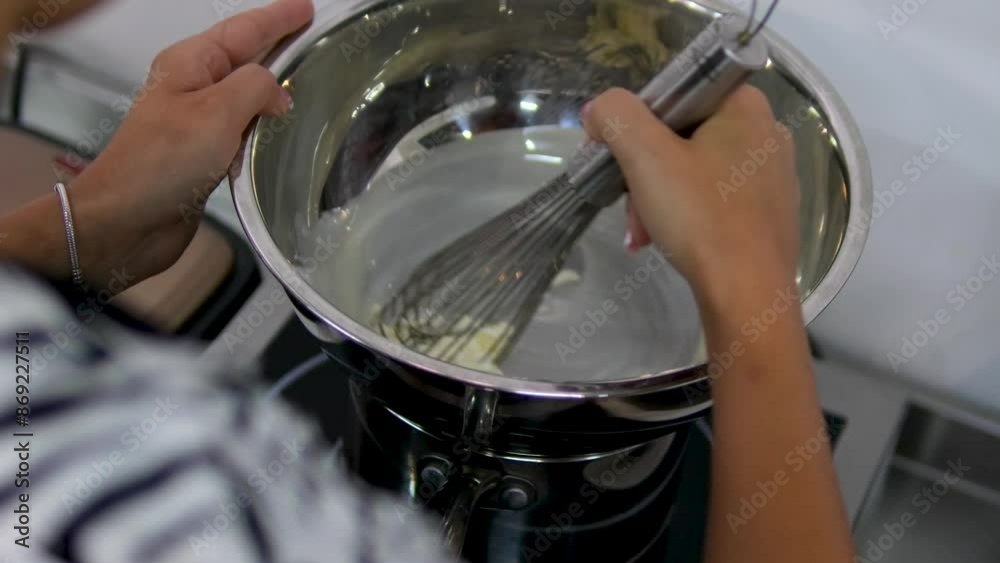 Melt butter in a water bath. Fast-paced footage of melting butter in a ...