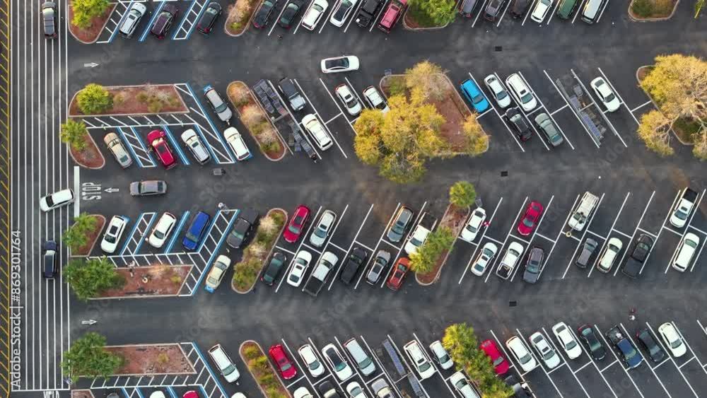 Many parked cars on store parking lot with lines and markings for ...