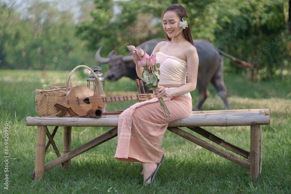 A pretty rural Asian woman lives a simple and happy life at home near ...