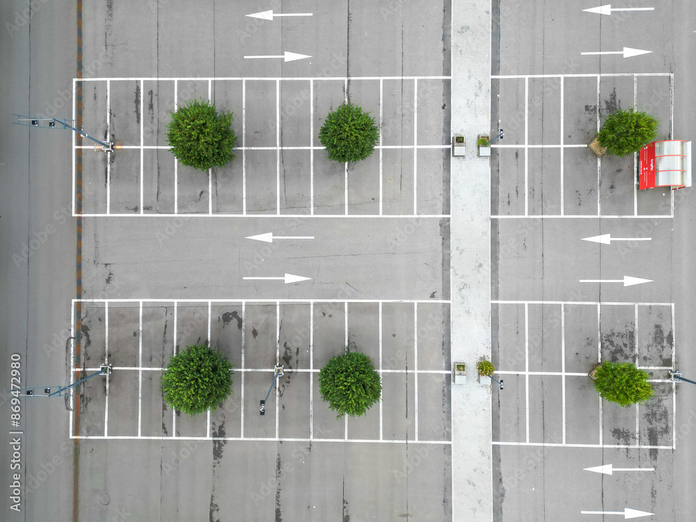 Aerial photo showing a neat, empty parking lot with white lines, green ...