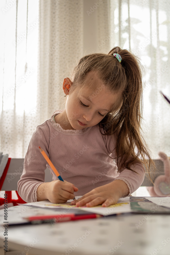 Cute little girl enjoys painting. Girl drawing and coloring picture ...