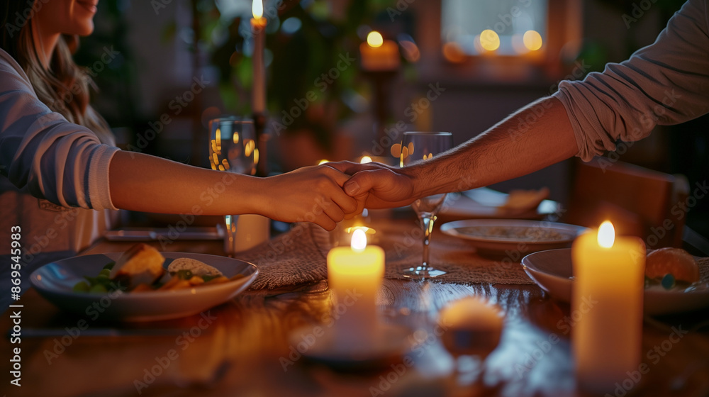 A romantic dinner date with a couple holding hands across the table ...