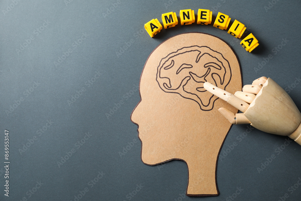 Yellow cubes with word Amnesia and mannequin hand pointing at drawing ...