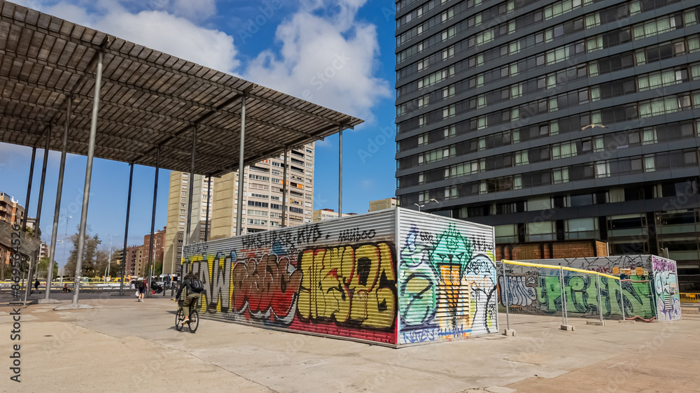 Colorful graffiti adorns urban structures under a modern pavilion in ...