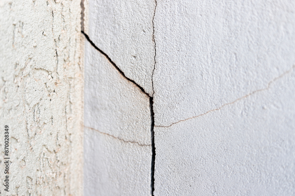 Crack in the wall. Cracks can be caused by soil movement, inadequate ...