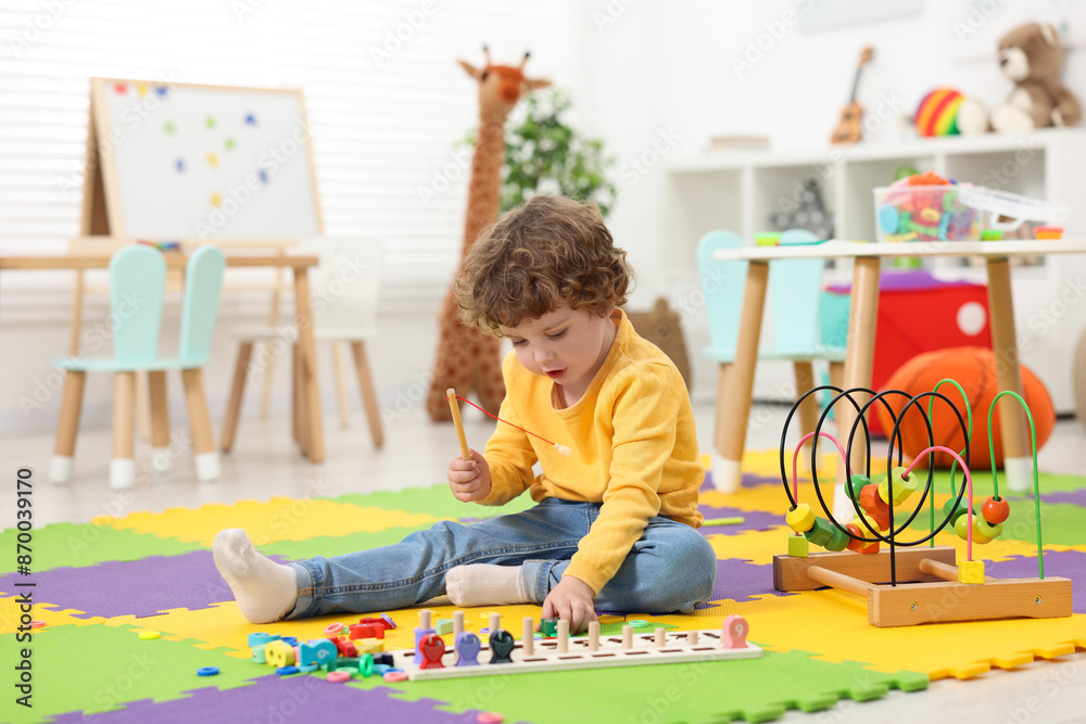 Cute little boy playing with math game Fishing for Numbers on puzzle ...