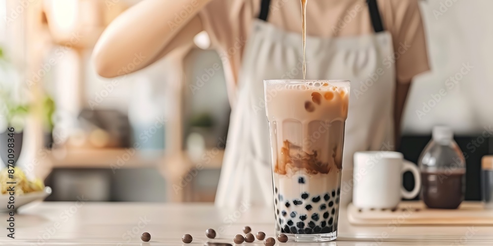Barista making bubble tea with milk, brown sugar, and tapioca pearls in ...