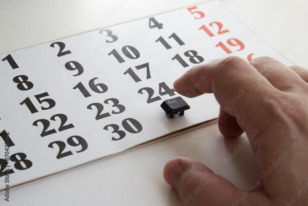Hand pressing the Escape key on the calendar instead of the last day of ...
