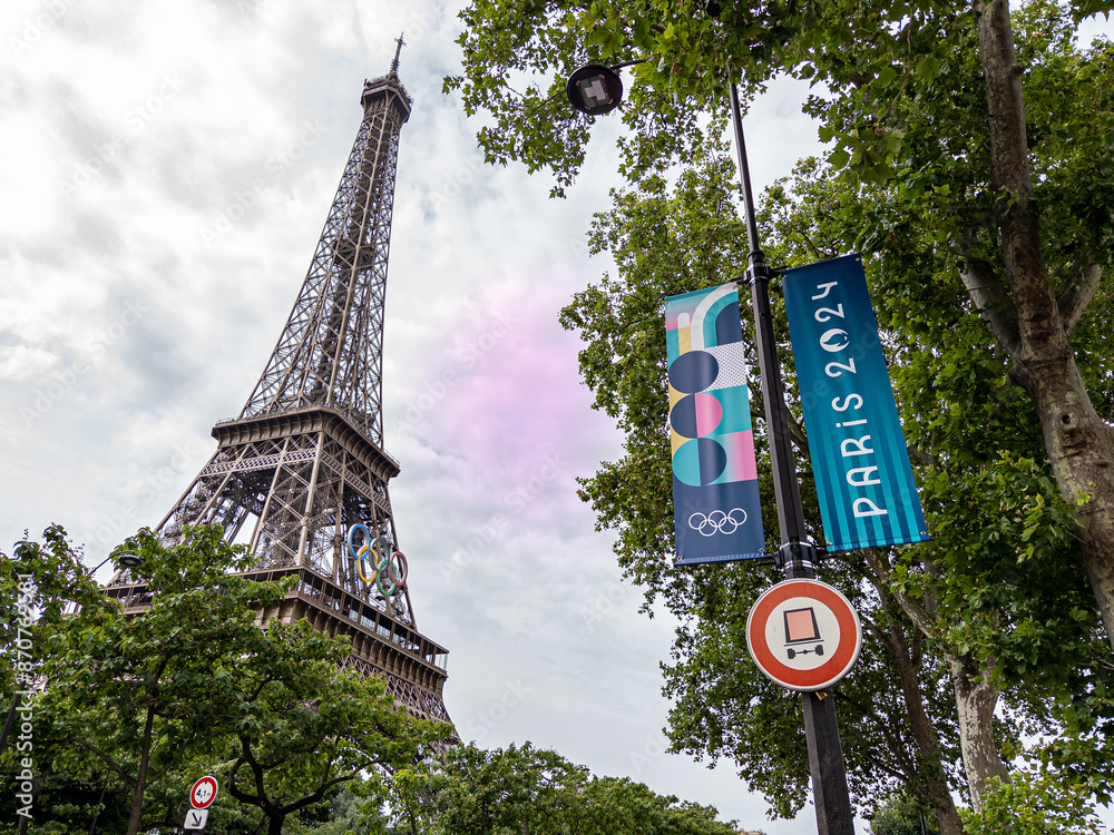 View of Eiffel Tower and Paris street banners with Paris 2024 Olympic ...