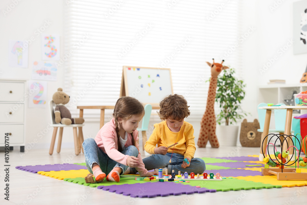 Cute little children playing with math game Fishing for Numbers on ...