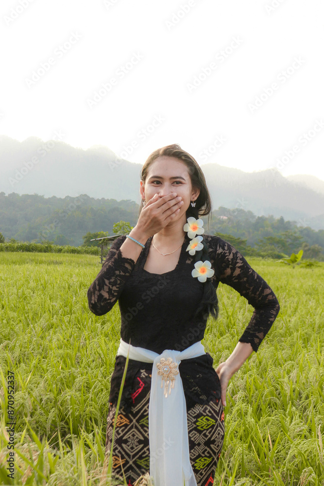 portrait of an Indonesian woman wearing a black Balinese kebaya in a ...