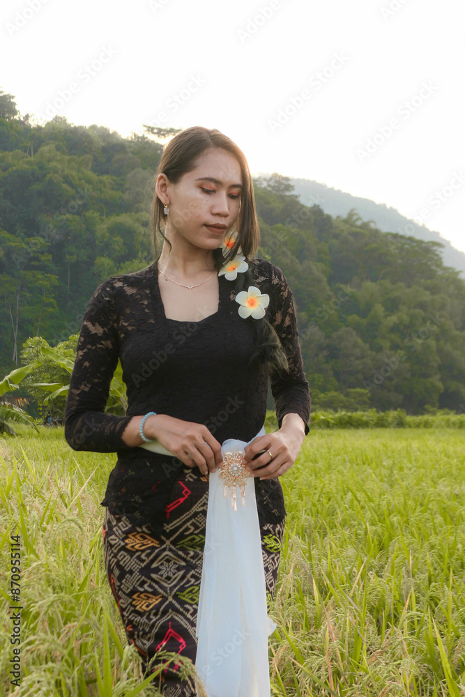 portrait of an Indonesian woman wearing a black Balinese kebaya in a ...