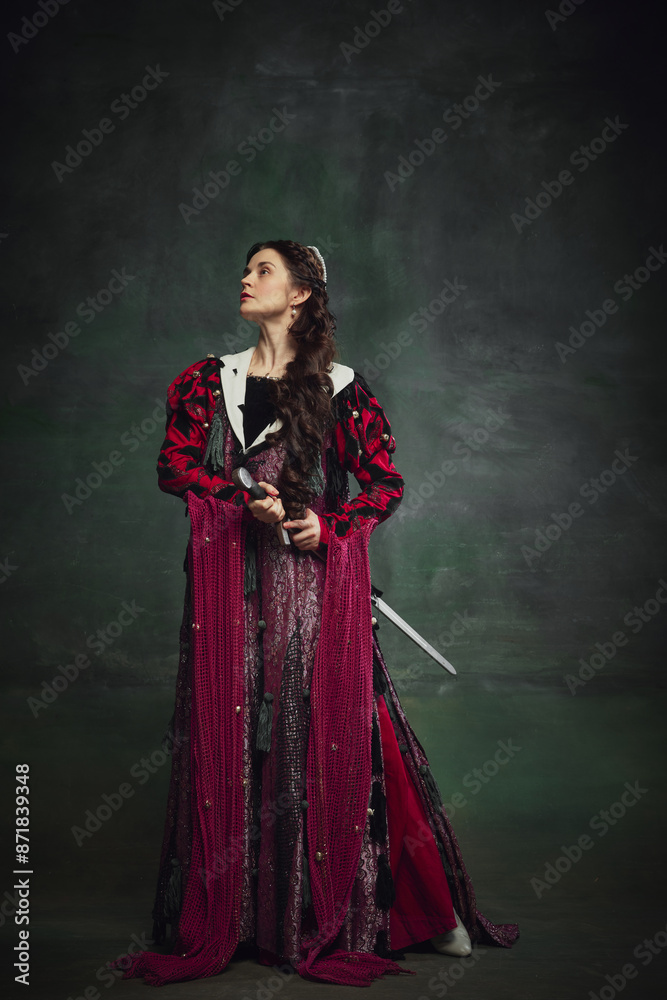 Portrait of medieval queen, brave woman holding sword with power and ...