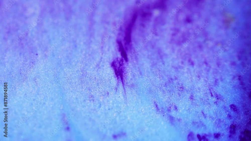 Sequin paint mix. Ink spill. Sparkling fluid. Defocused blue purple ...