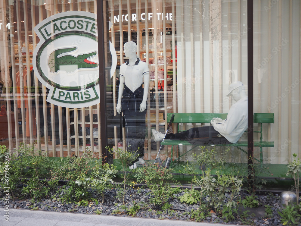 TOKYO, JAPAN - March 31, 2024: Display in the window of a Lacoste store ...