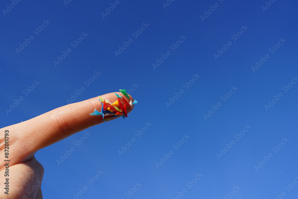 Microplastic pollution. Microplastics Microplastic on finger of hand ...