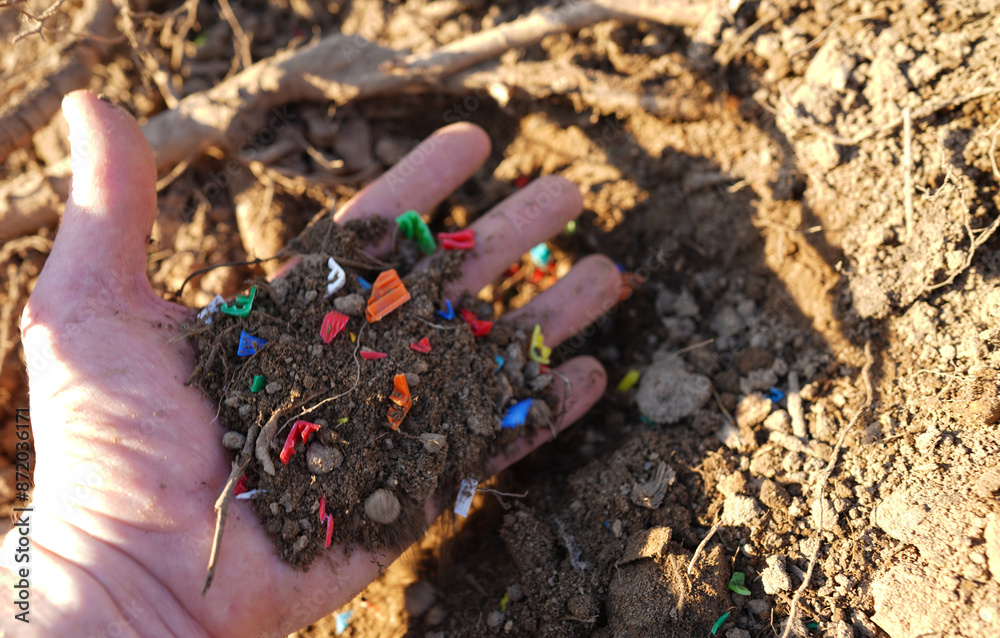 Microplastic pollution. Microplastics in ground. Soil contaminated with ...